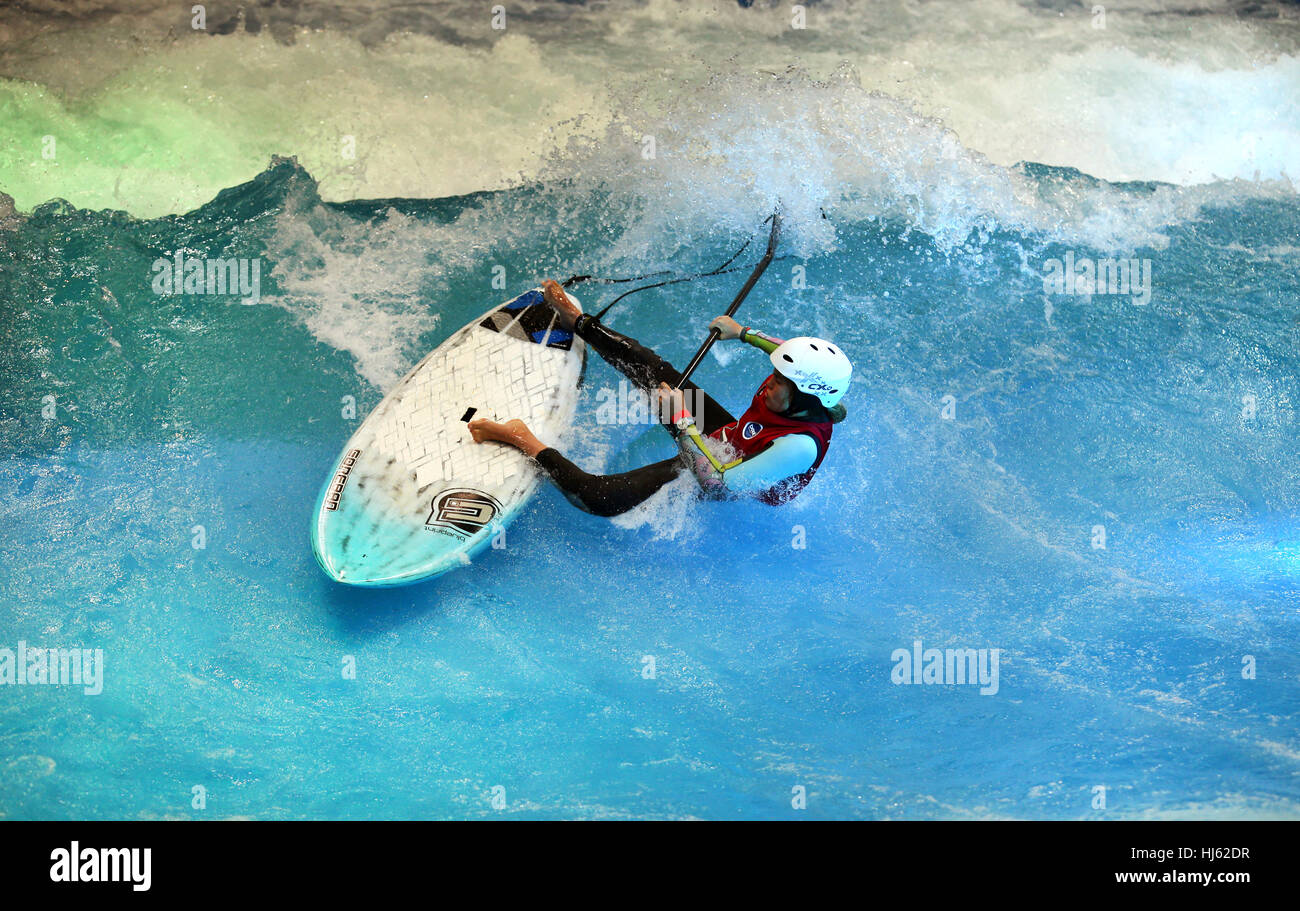 A surfer falls from a surfboard at the international boat exposition in ...