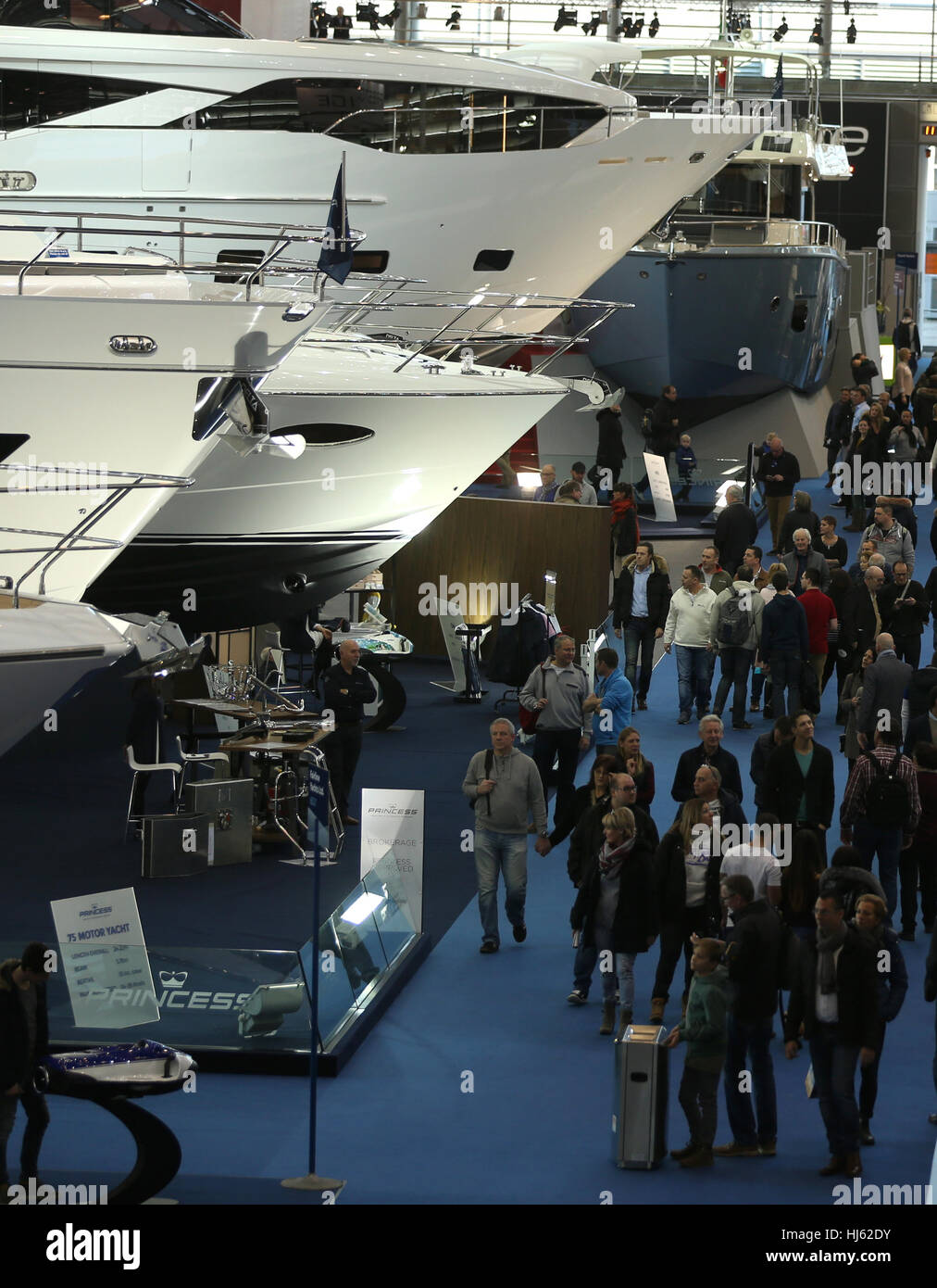 Visitors walk between yachts on display at the international boat ...