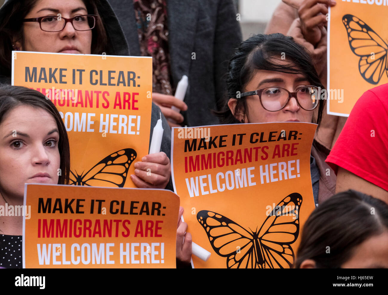 Los Angeles, USA. 25th Jan, 2017. People hold banners and candles ...