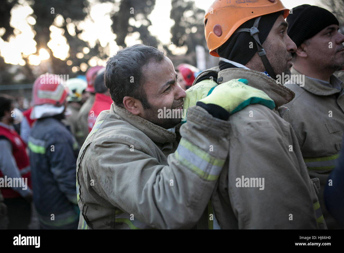 Tehran, Iran. 25th Jan, 2017. A firefighter cries for his colleagues ...