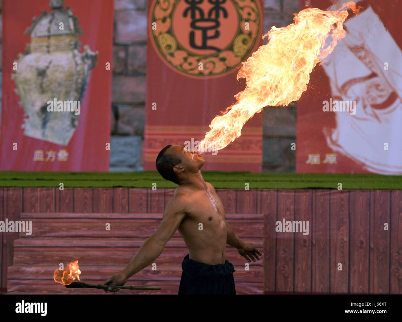 Changsha, Hunan, China. 26th Jan, 2017. An actor performs fire spitting ...