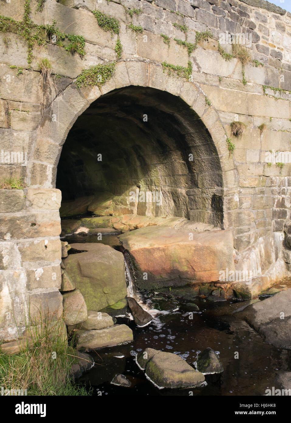 Stone bridge over stream with peaty water, Peak District National Park ...