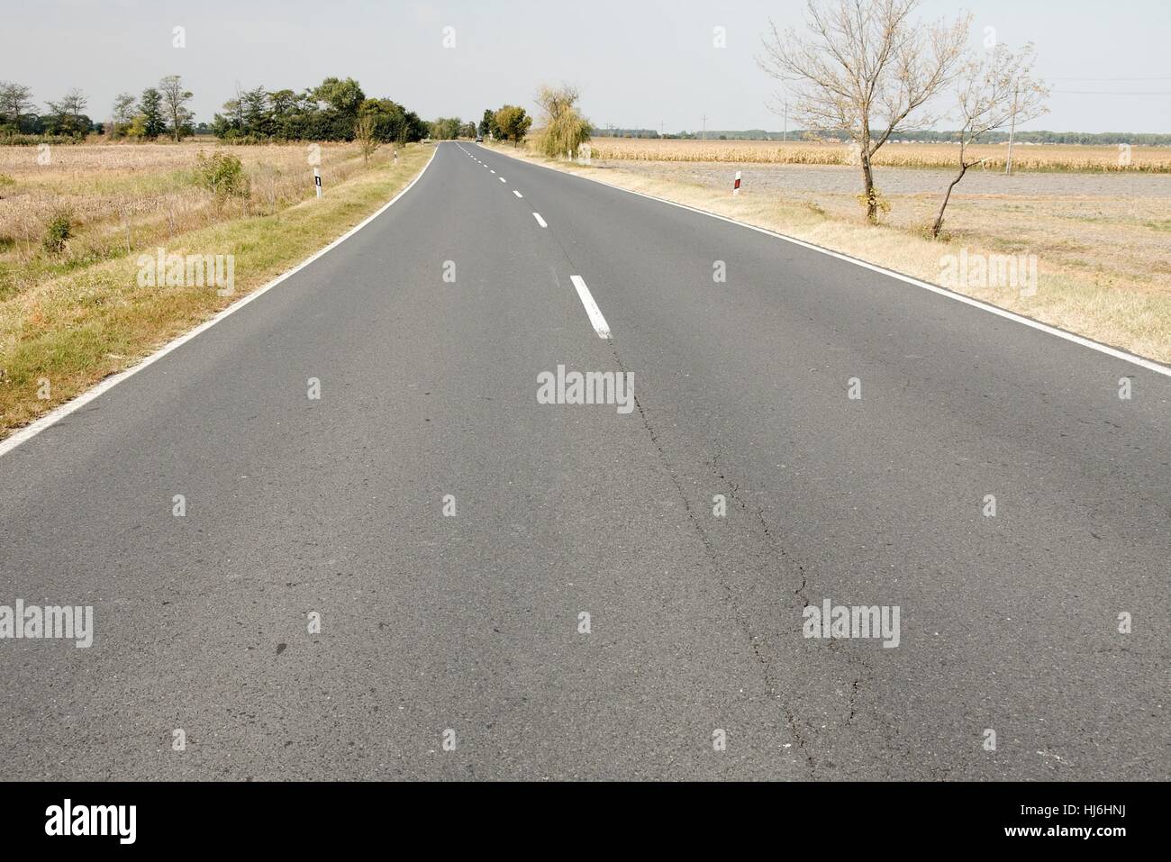 Road going through the countryside Stock Photo - Alamy
