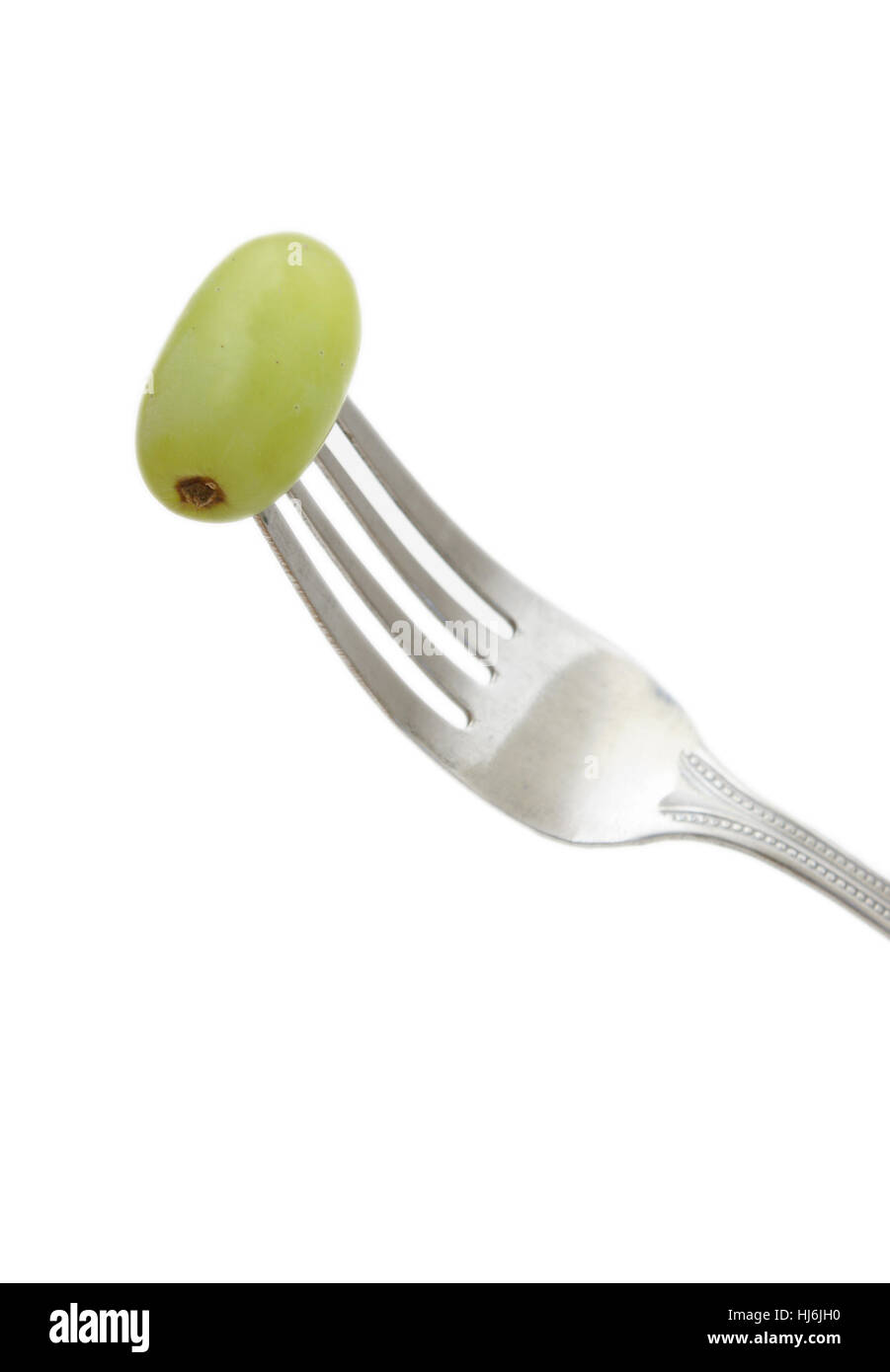A fork with a grape on it to show healthy eating Stock Photo - Alamy