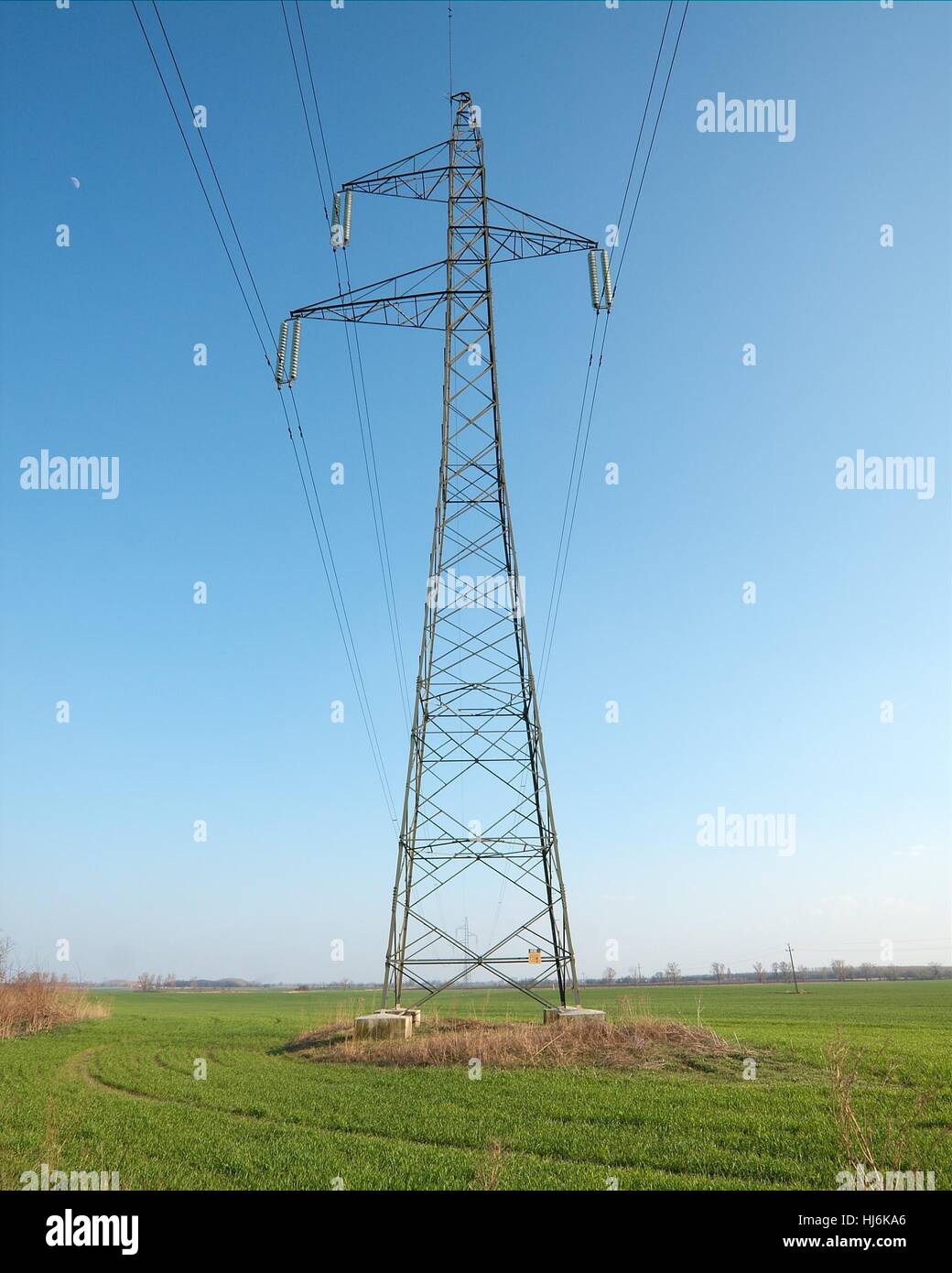 High voltage electric pillar over an agricultural field Stock Photo - Alamy