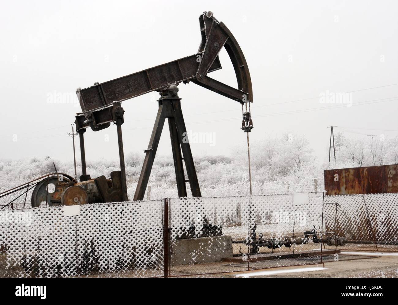 Old rusty oil well on a winter land Stock Photo - Alamy