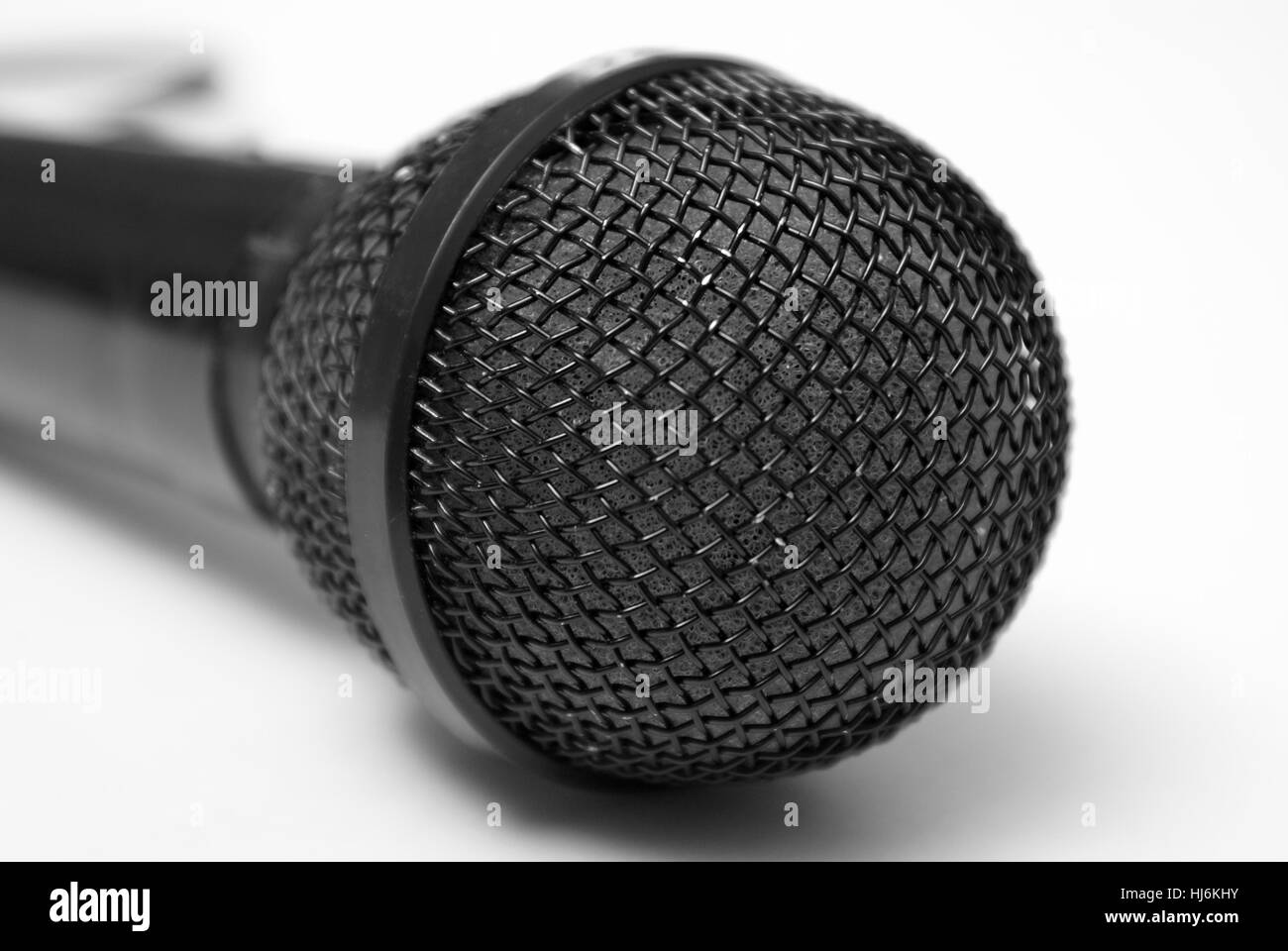 A macro shot of a microphone over a white background Stock Photo - Alamy