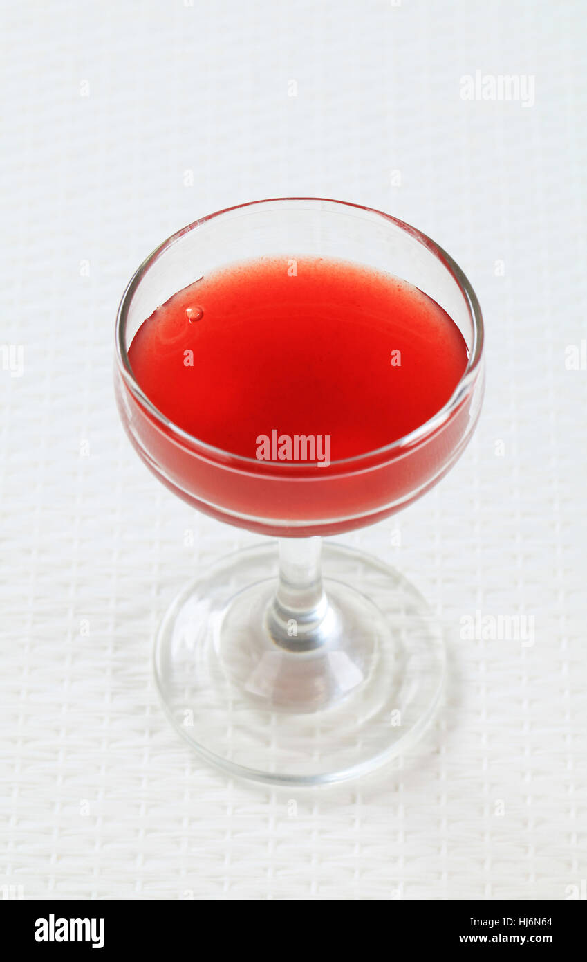 Red juice in a wine glass Stock Photo - Alamy