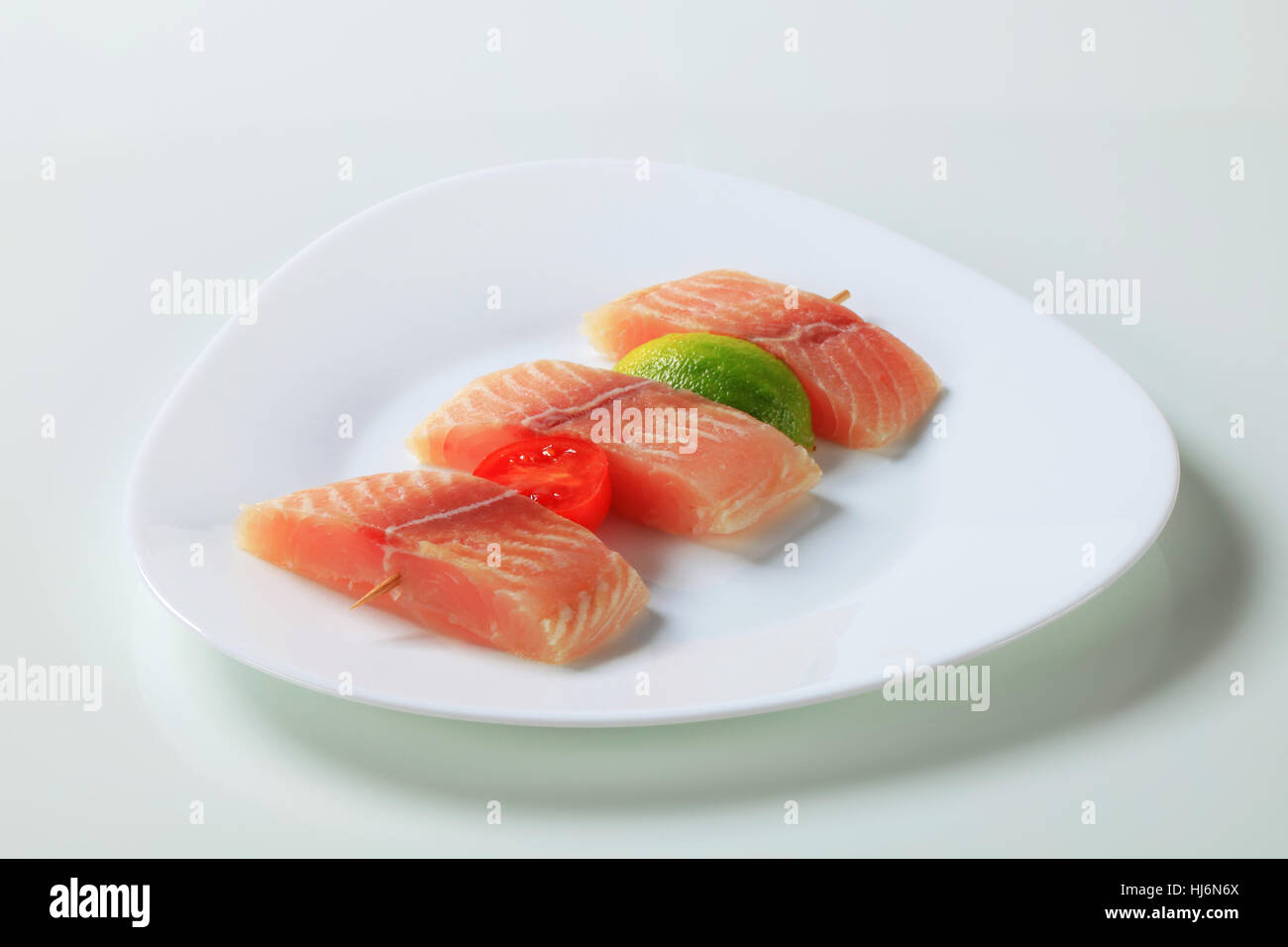 Raw fish skewer on a plate Stock Photo - Alamy