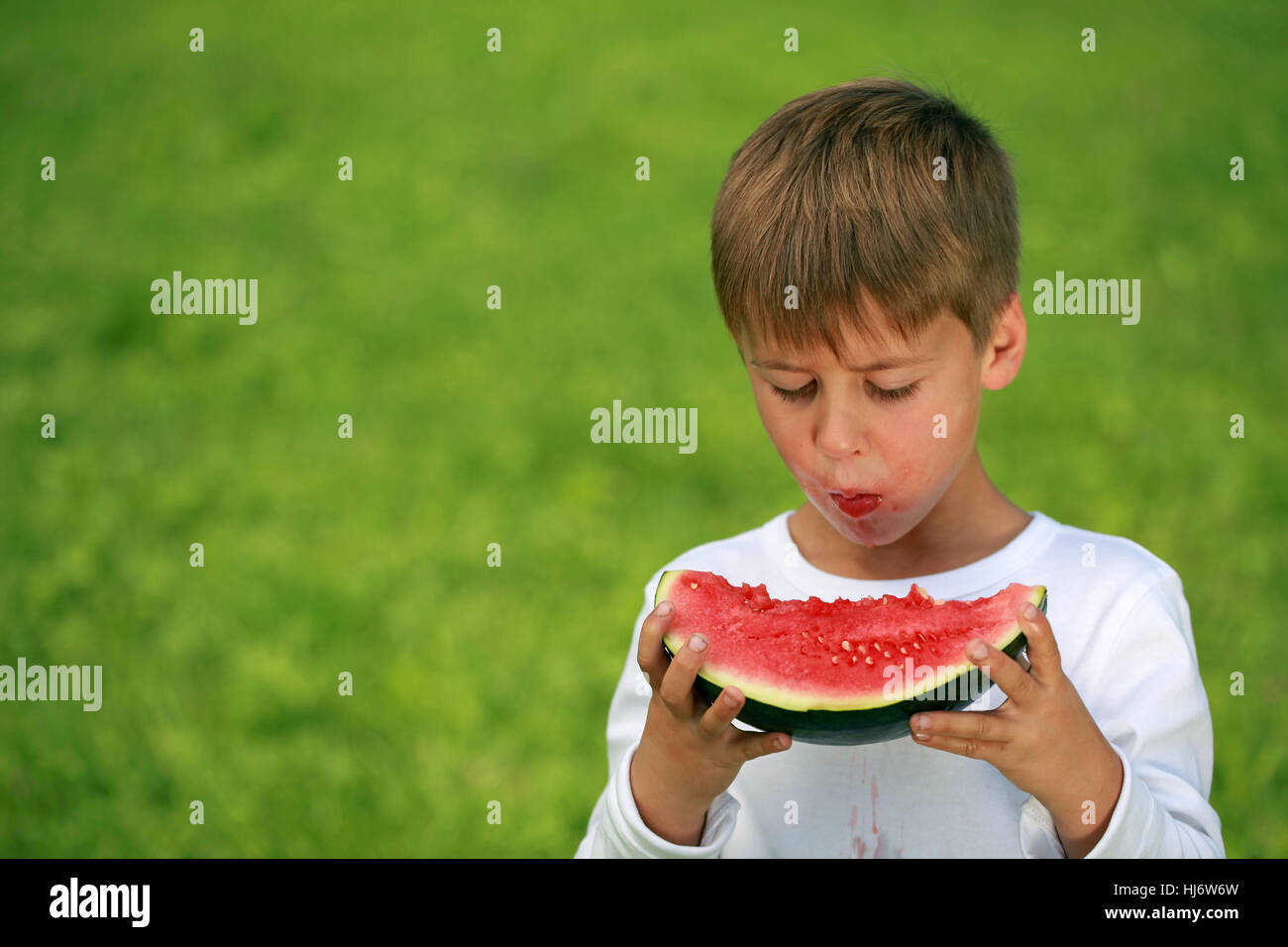 boy eating watermelon and makes stains Stock Photo - Alamy