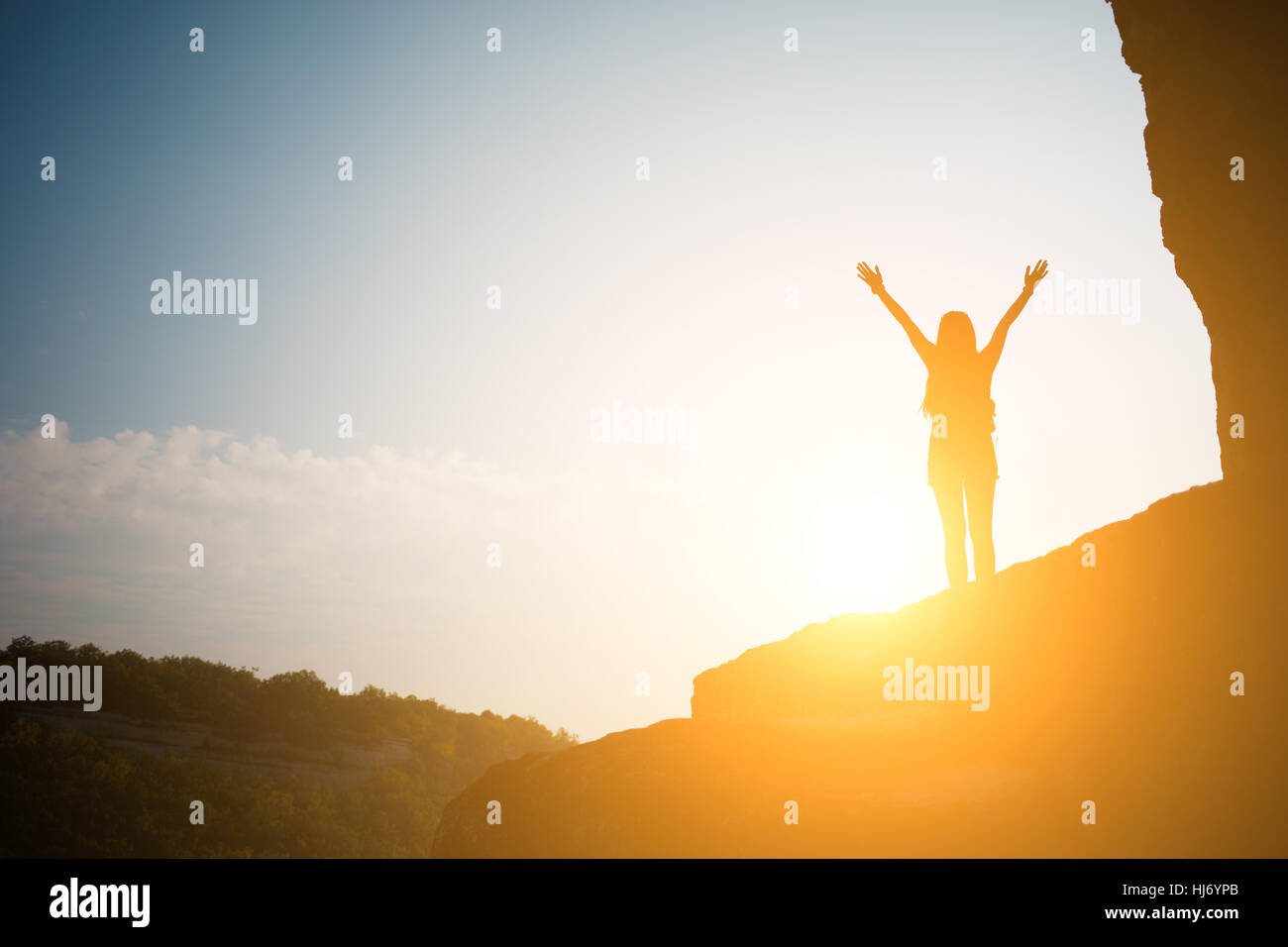 Girl against sun on mountain Stock Photo - Alamy