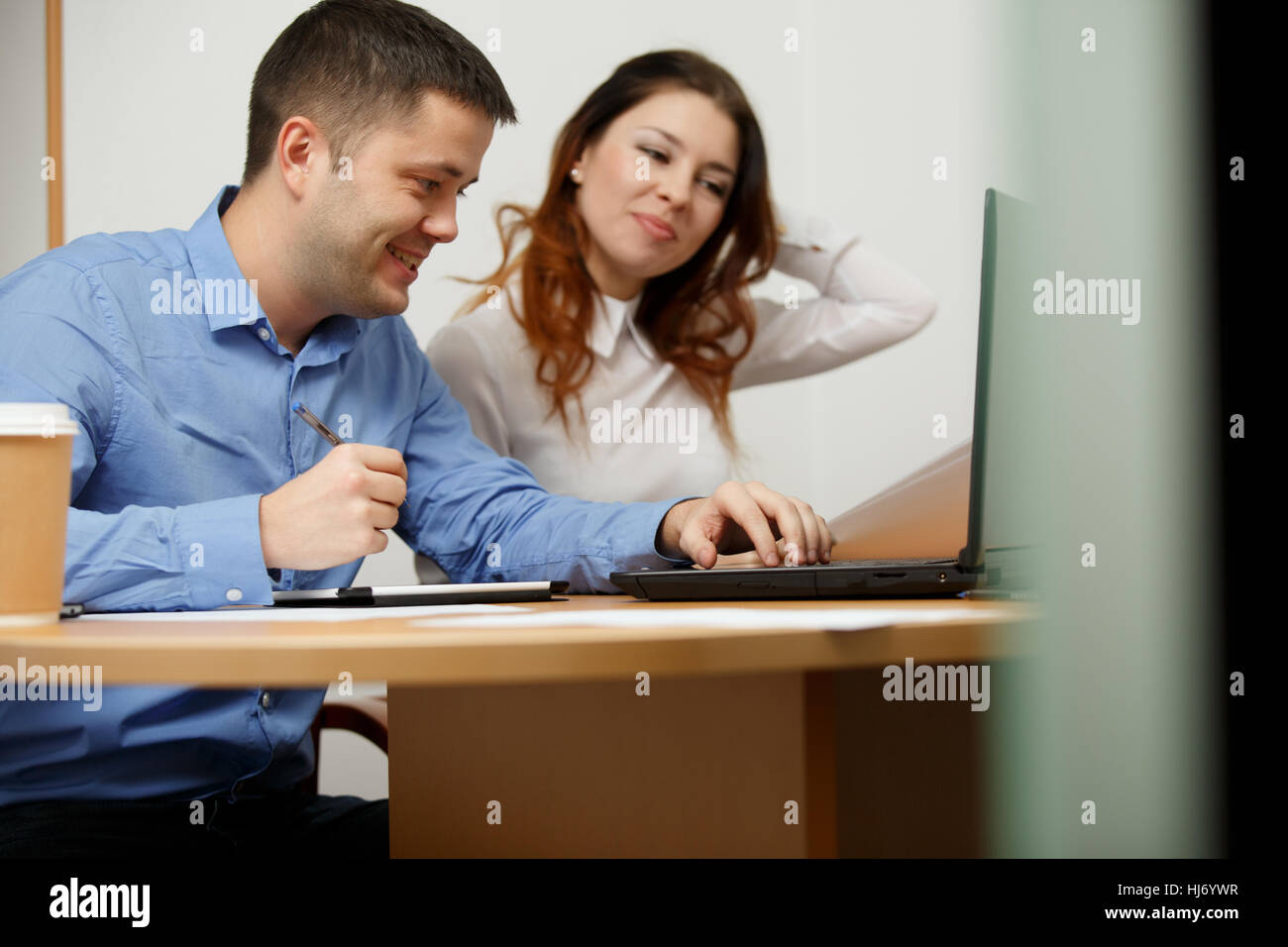 Office workers sitting at desk Stock Photo - Alamy