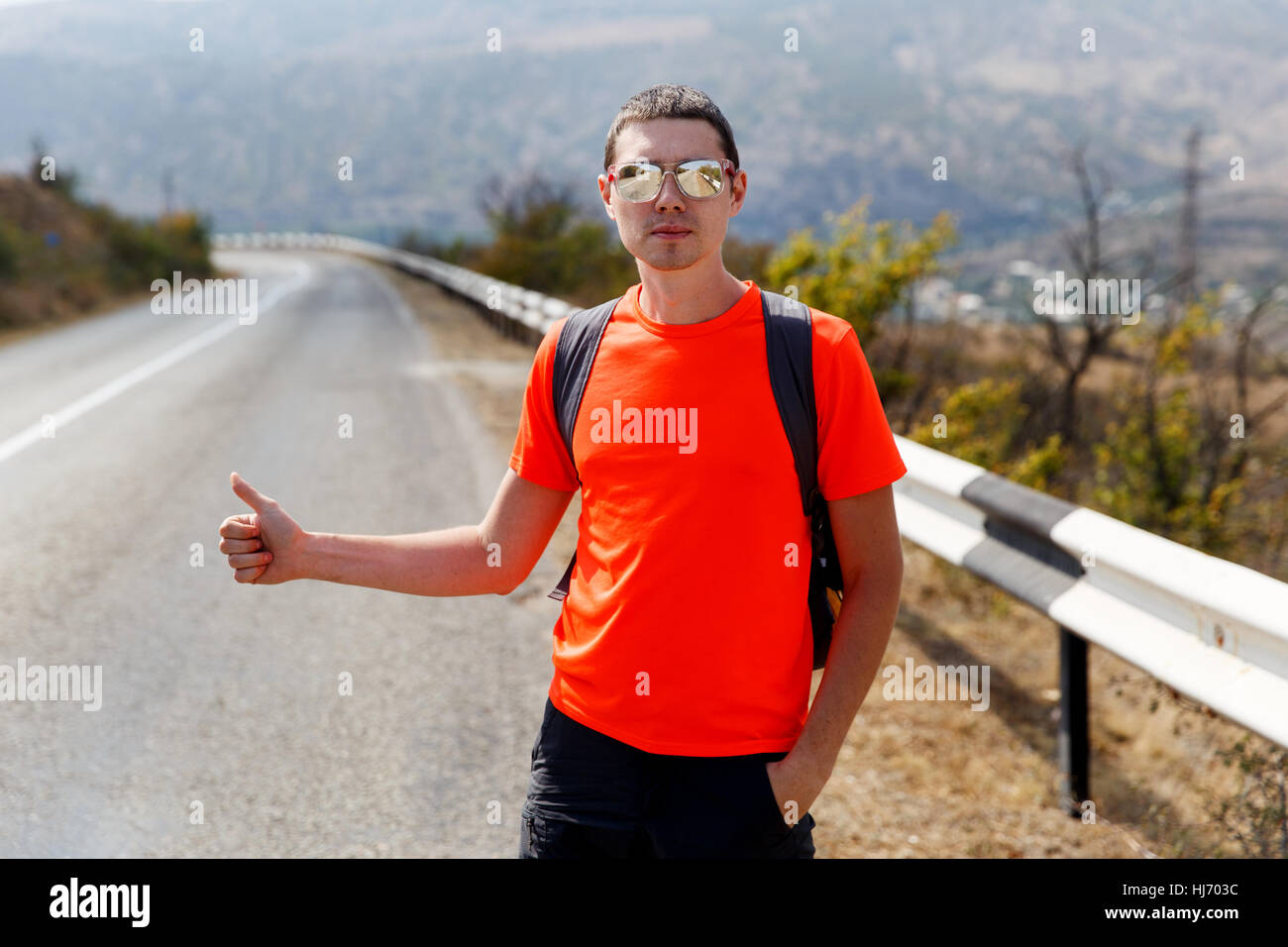 Man on road , hand raised Stock Photo - Alamy