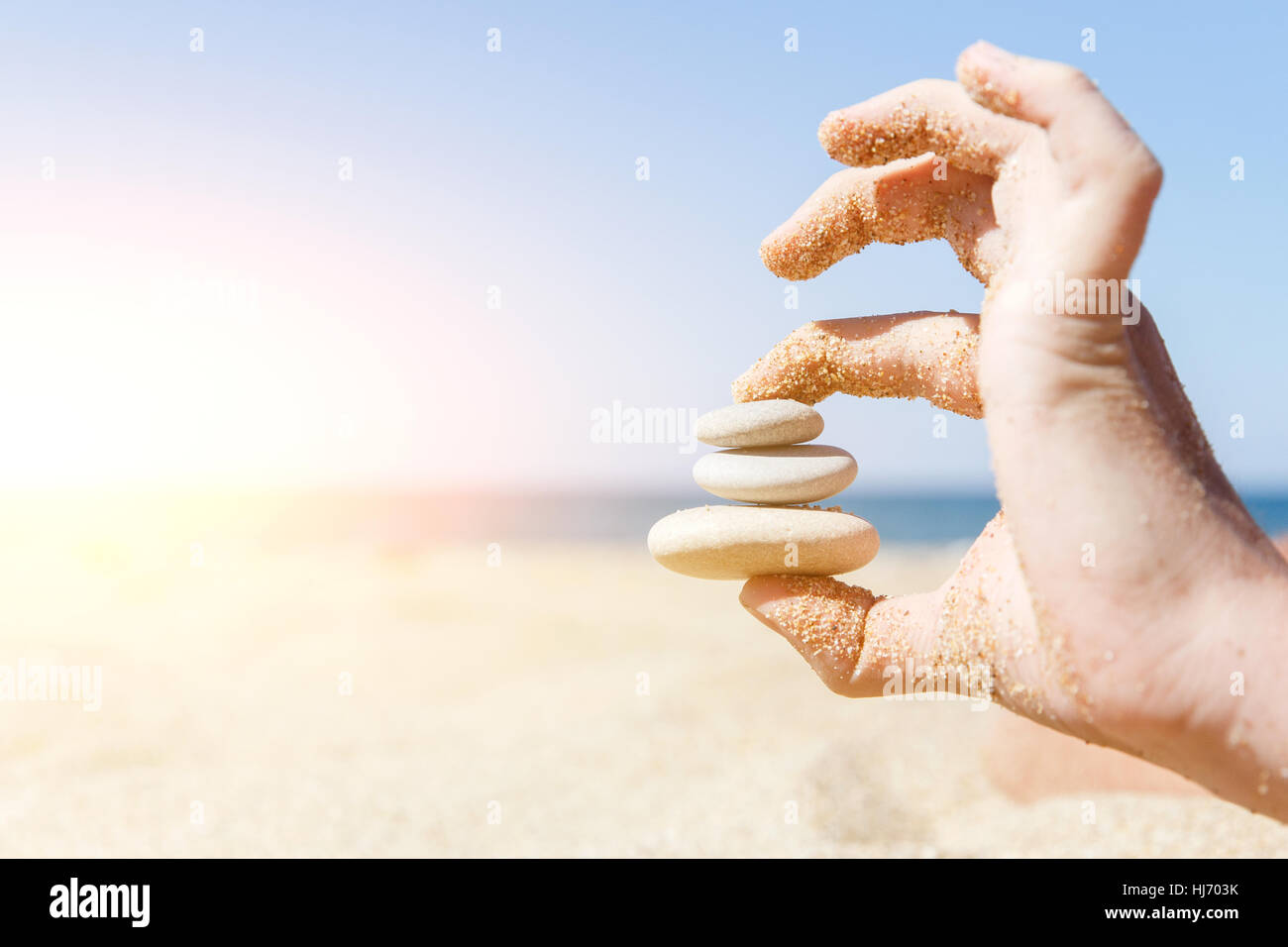 Man holds pyramid of stone Stock Photo - Alamy