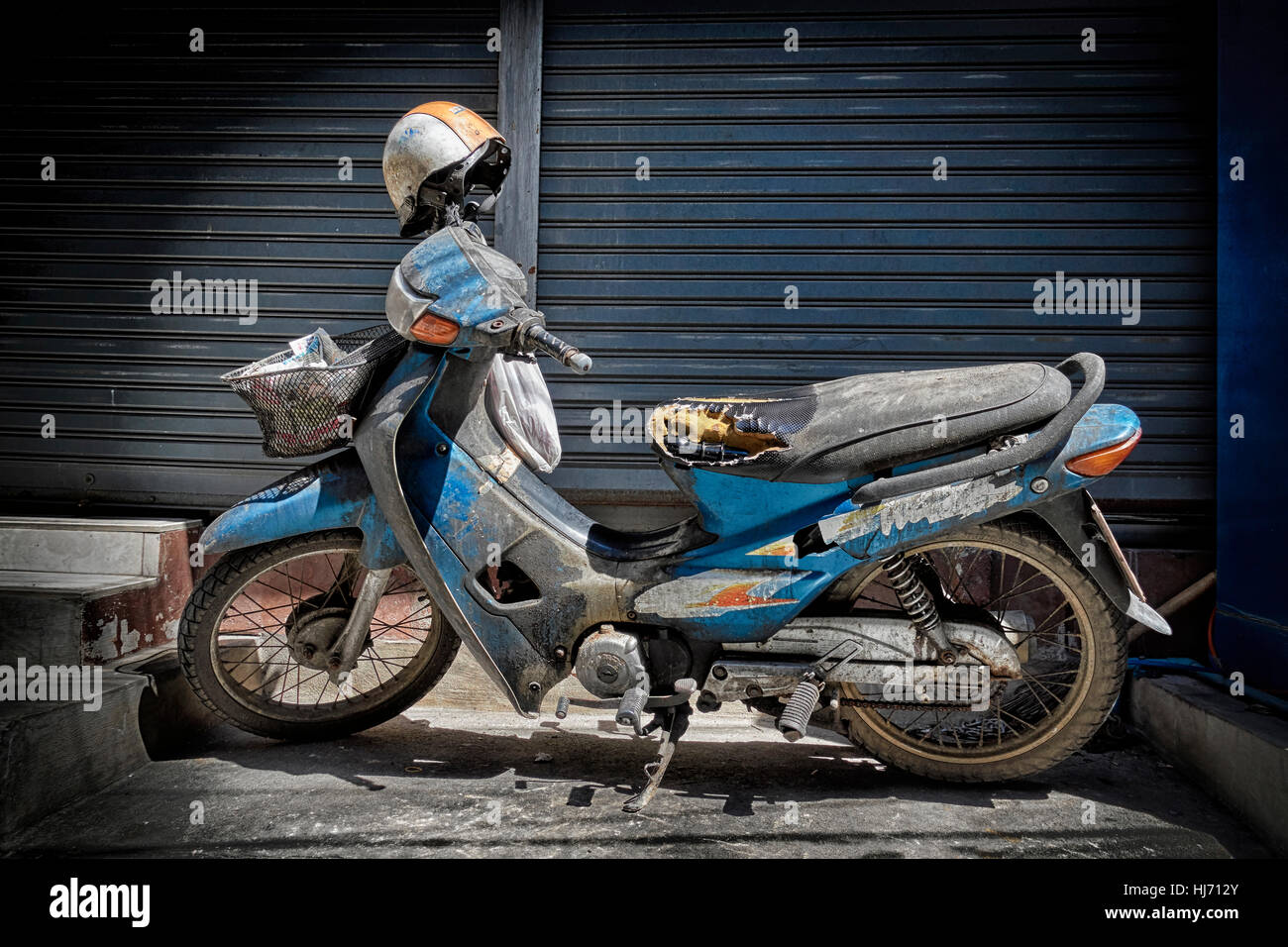 Rusty motorcycle. Well worn and tatty motorbike having seen better days ...