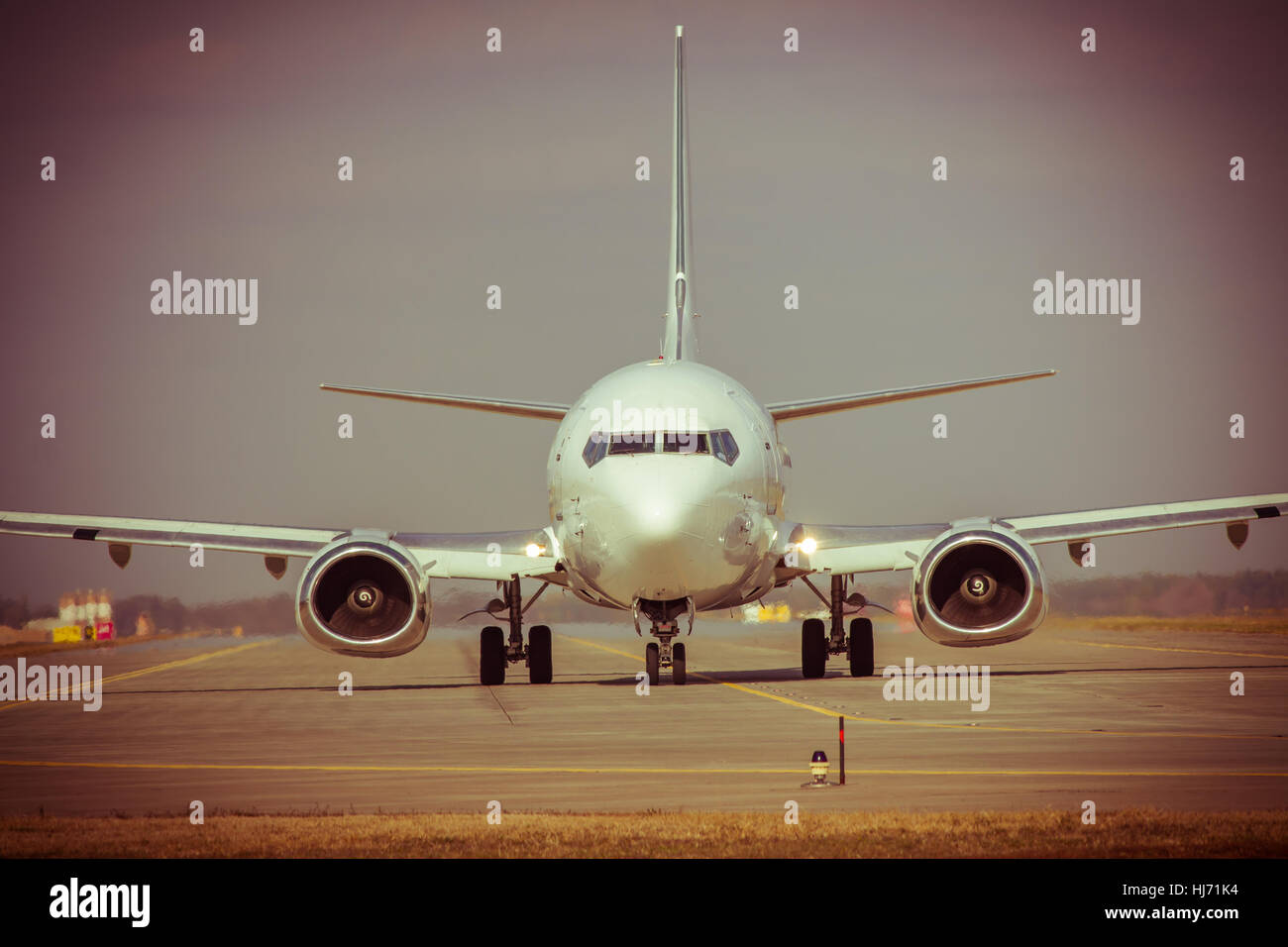 Passenger plane taxiing along the airport taxiway Stock Photo - Alamy