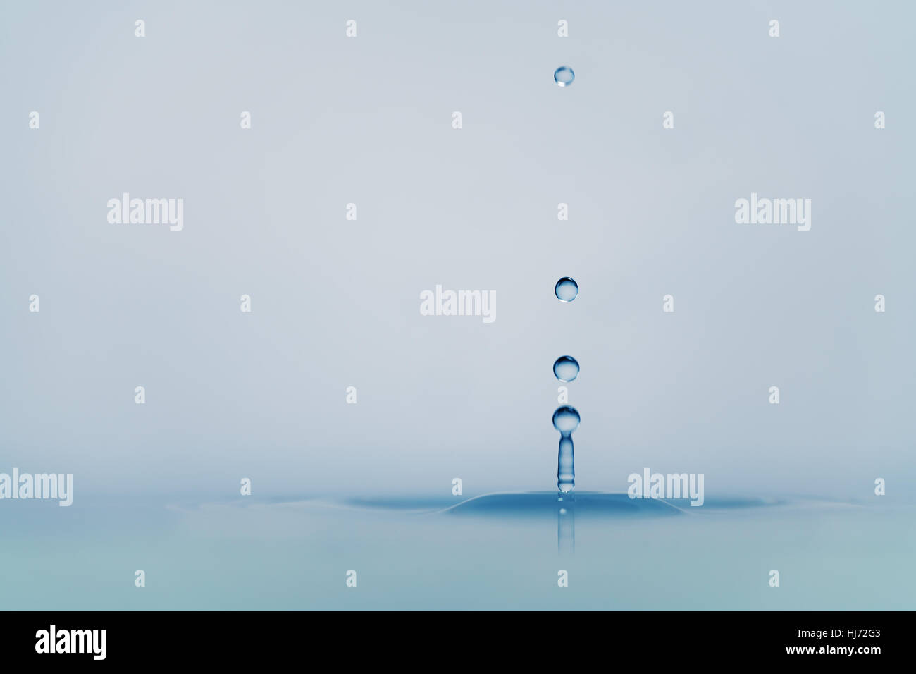 clear blue water drop with ripple on surface Stock Photo - Alamy