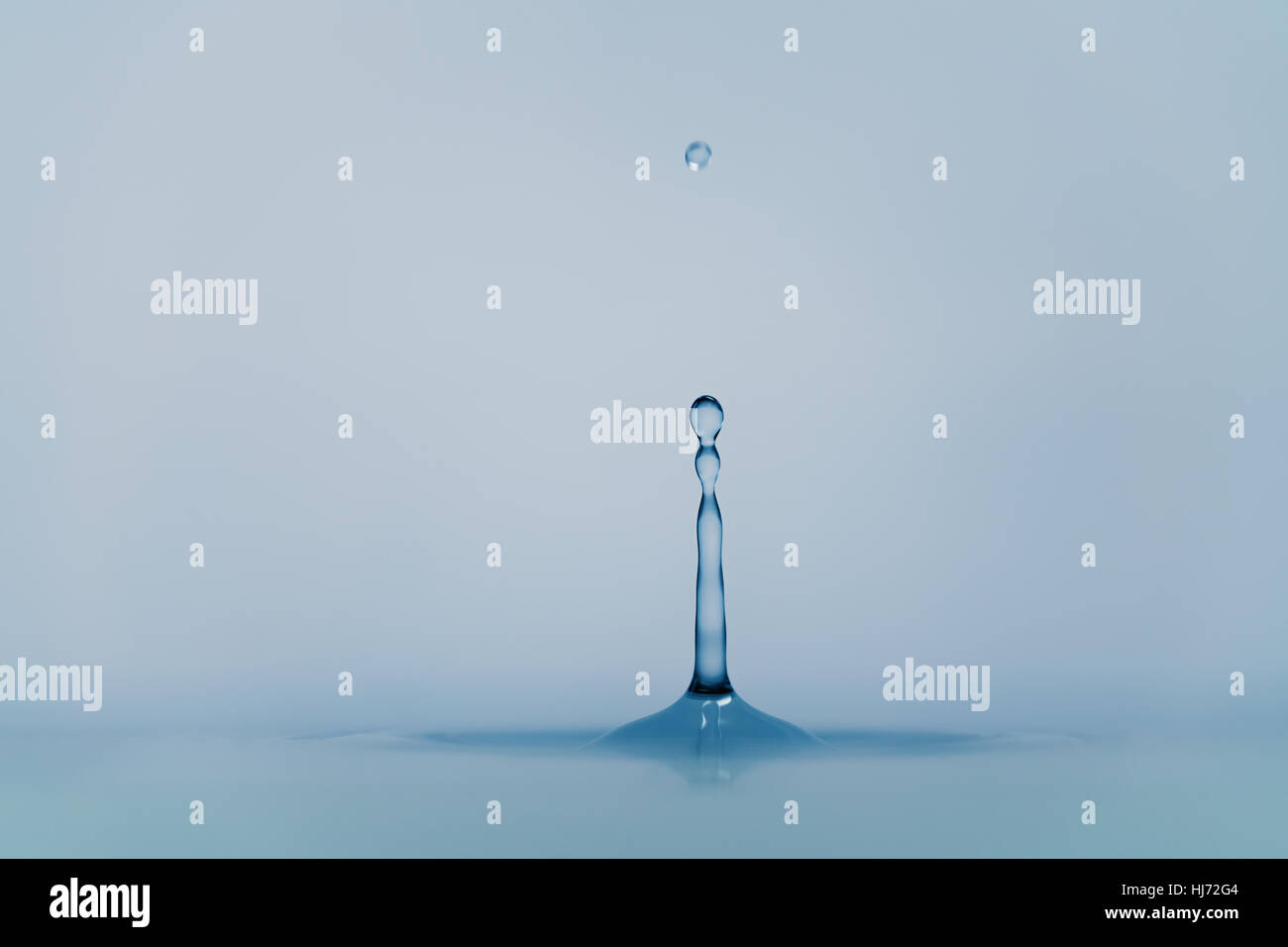 clear blue water drop with ripple on surface Stock Photo - Alamy