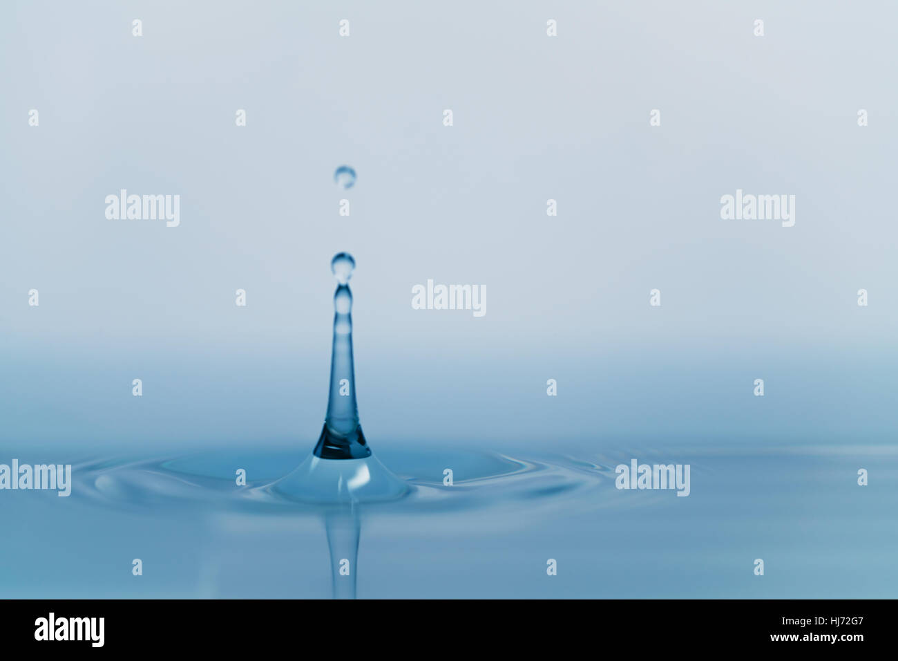 clear blue water drop with ripple on surface Stock Photo - Alamy
