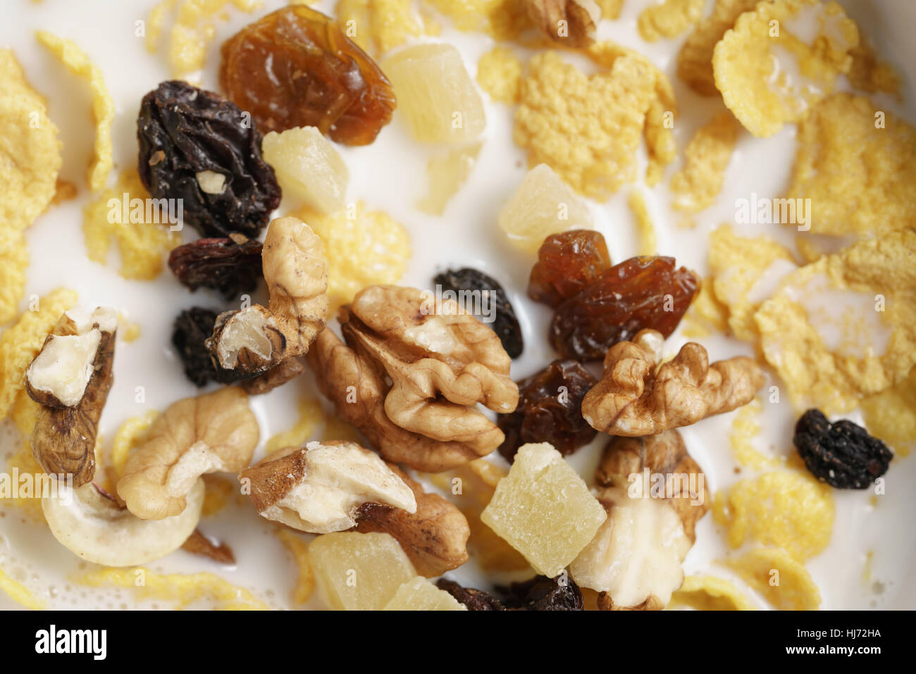 macro photo of corn flakes with fruits and nuts in bowl Stock Photo - Alamy