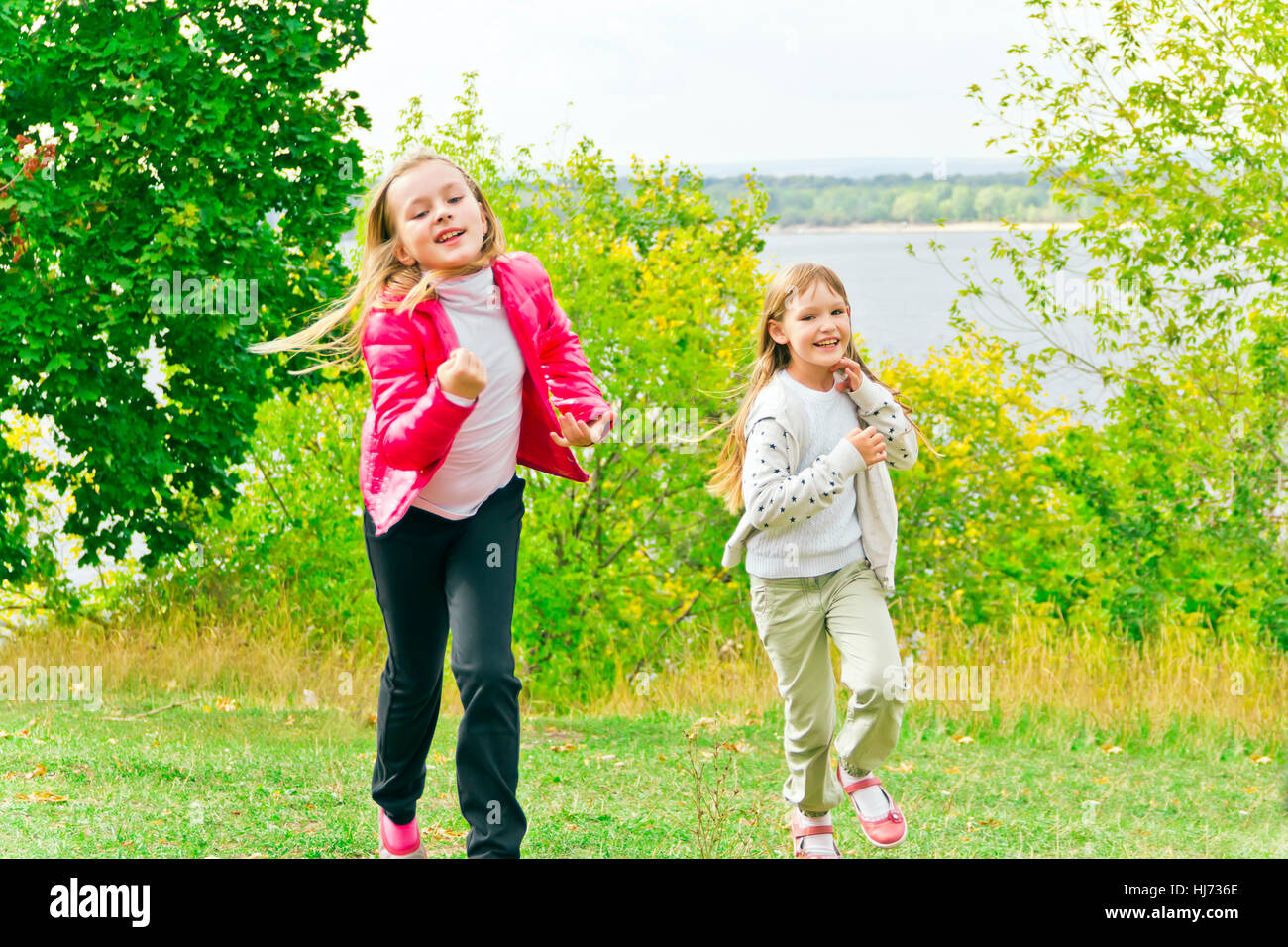 Photo of two running girls in summer Stock Photo - Alamy