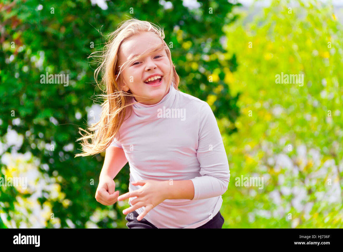 Photo of cute running girl in summer Stock Photo - Alamy