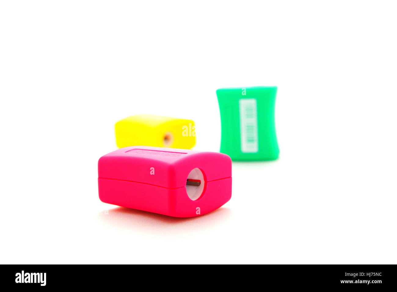 three sharpeners, pink, yellow and green on a white background Stock ...