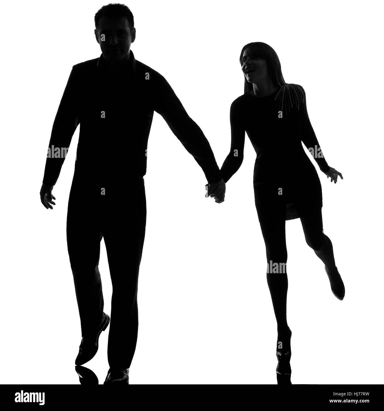 one caucasian couple man and woman running hand in hand in studio ...