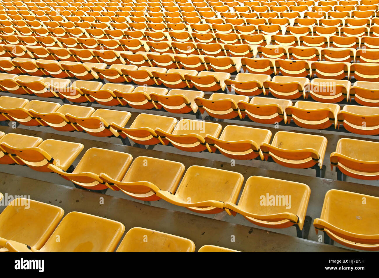 Perspective of yellow seats in football stadium, pattern background ...