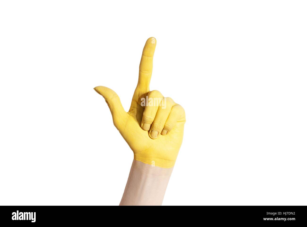 a check mark gesture of a yellow painted hand, isolated Stock Photo - Alamy