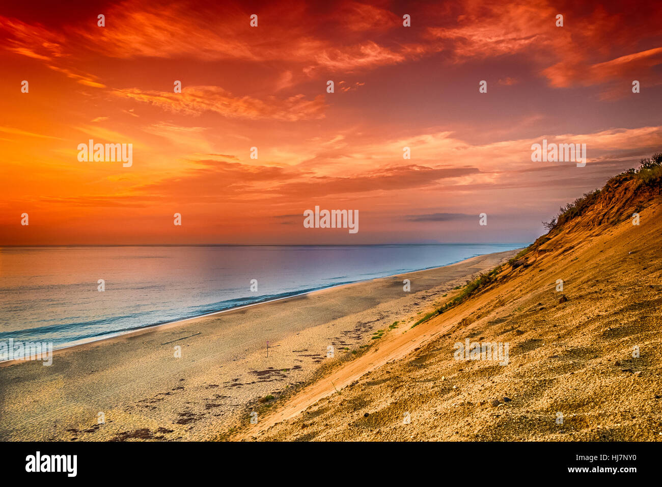 A warm morning sunrise promising a relaxing beach day Stock Photo - Alamy