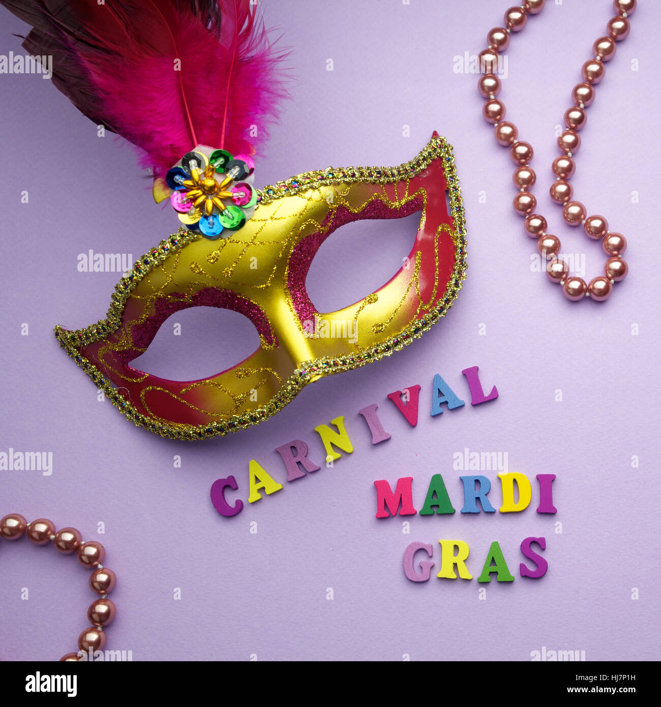Colorful mardi gras or carnivale mask on a purple background. Venetian ...