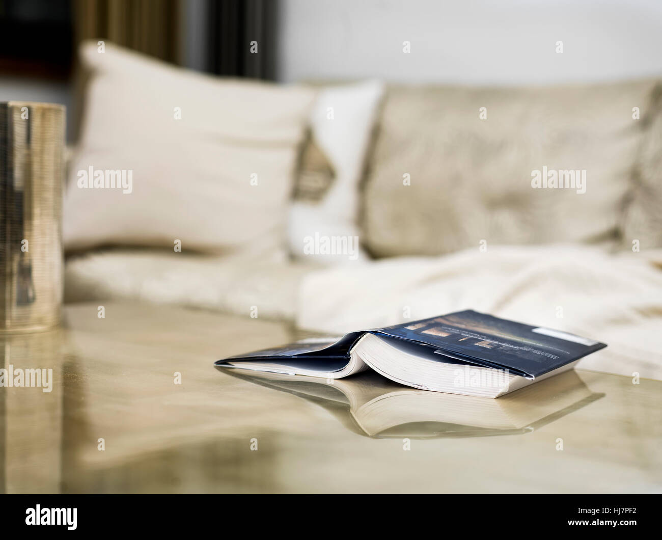 Open book in focus laid on the table, indoor shot with blurred ...