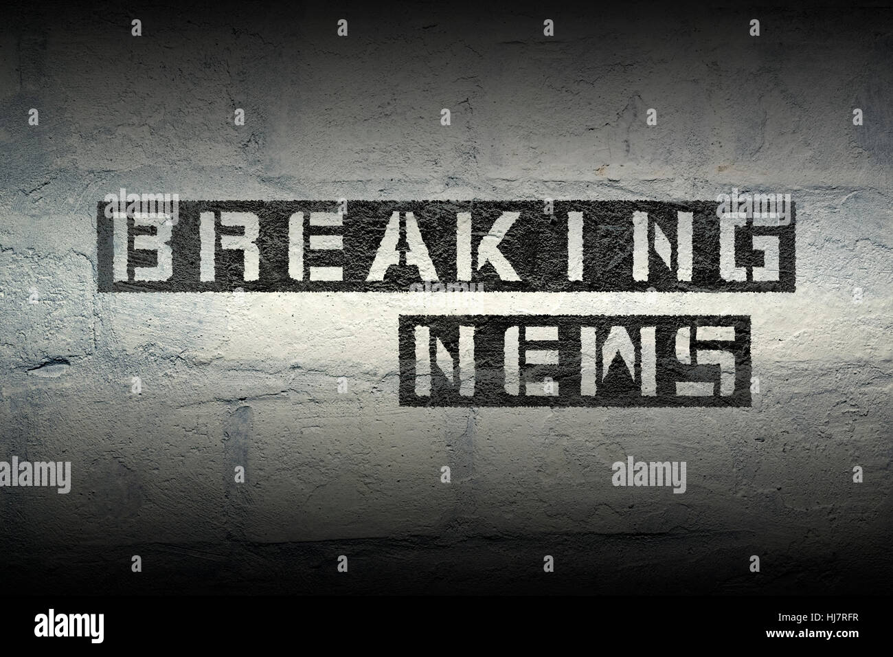 breaking news stencil print on the grunge white brick wall; specially ...