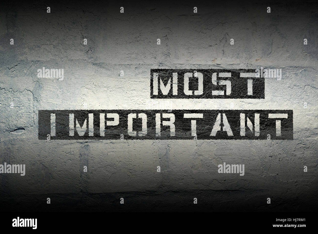 most important stencil print on the grunge white brick wall Stock Photo ...