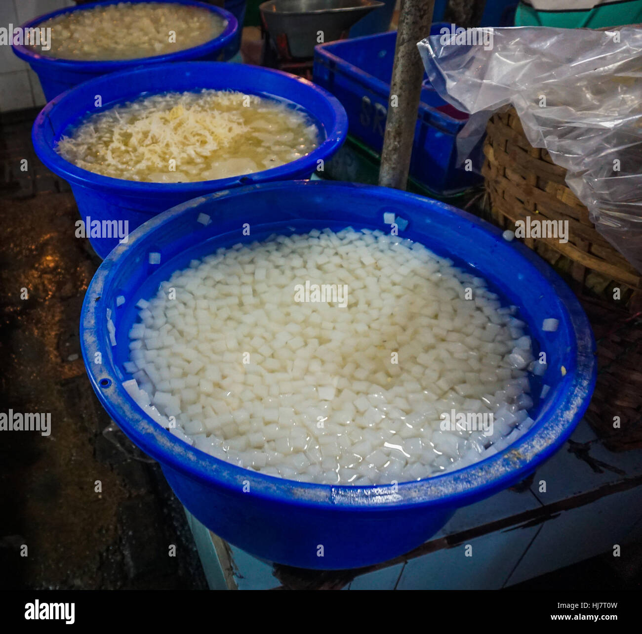 selling Nata de coco and seaweed in blue plastic bucket at traditional ...