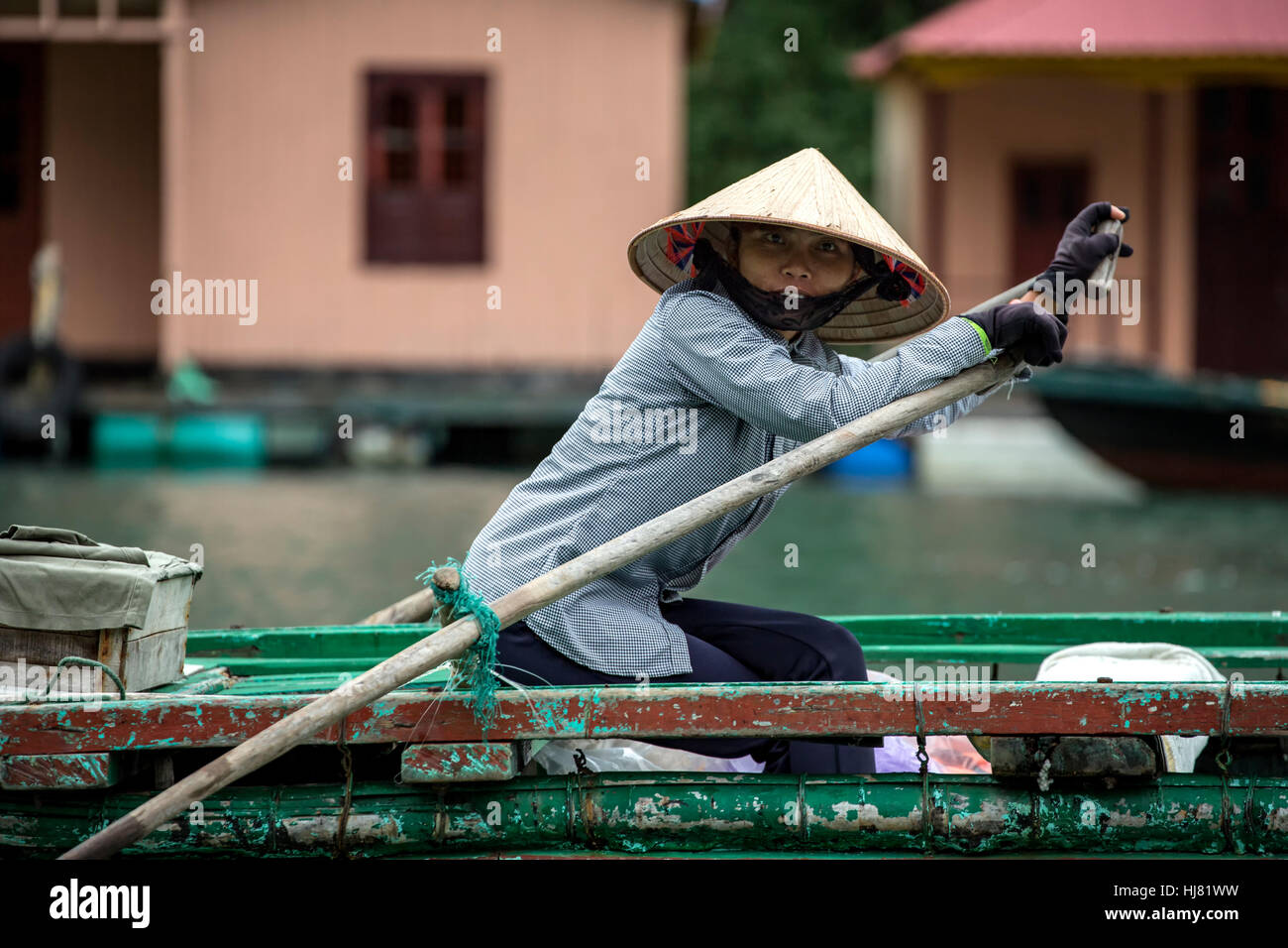 Woman rowing wooden rowboat, Vung Vieng fishing village, Ha Long Bay ...