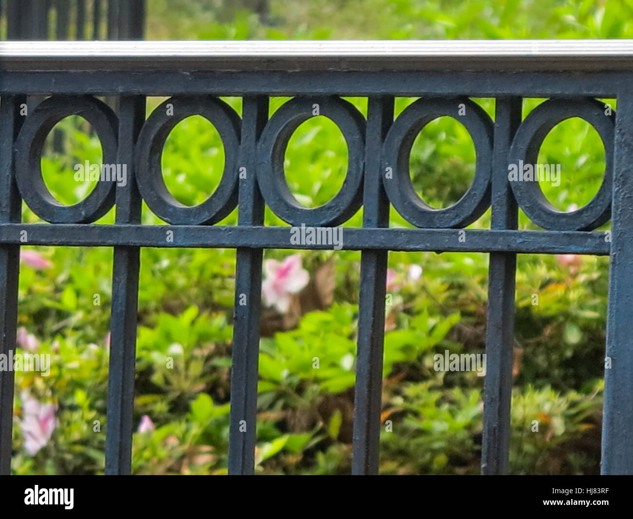A black iron fence with circle design Stock Photo - Alamy