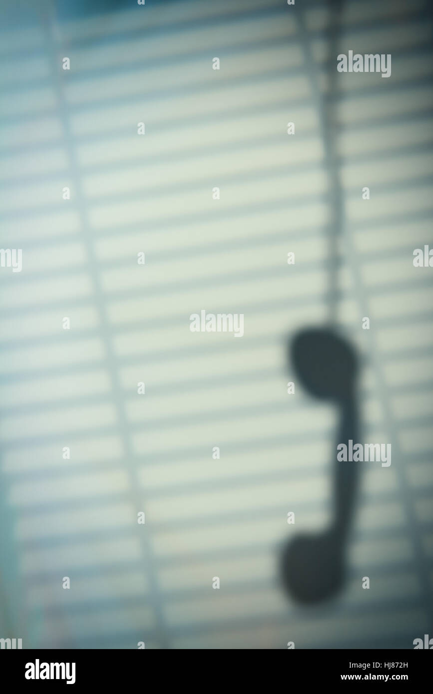 Shadow of receiver of vintage black telephone hanging by its cord Stock ...