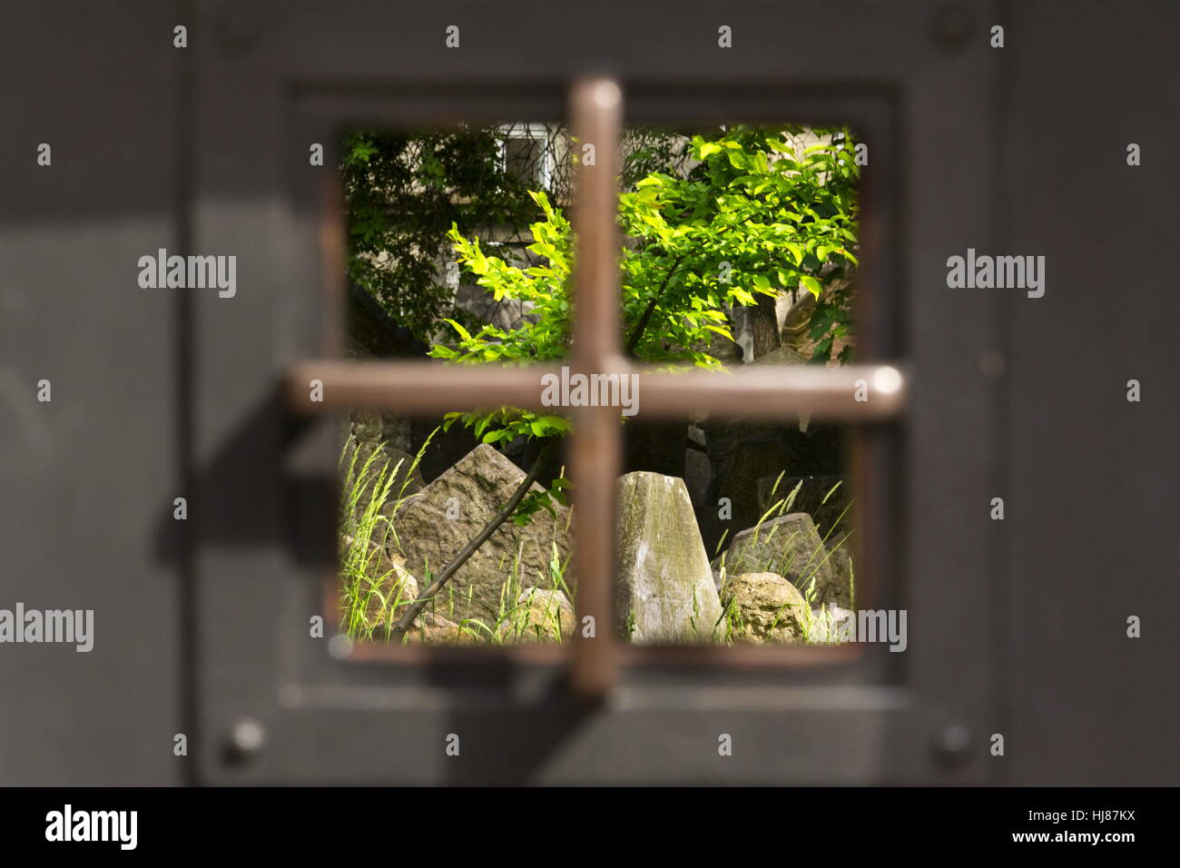 Old Jewish Cemetery through gridded window in Prague, Czech republic ...