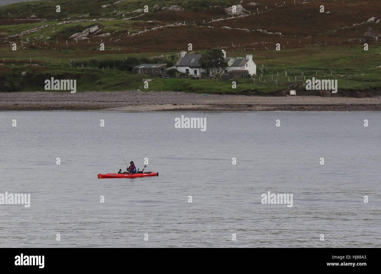 Angler fishing from a kayak in Ballinskelligs Bay, Ballinskelligs ...