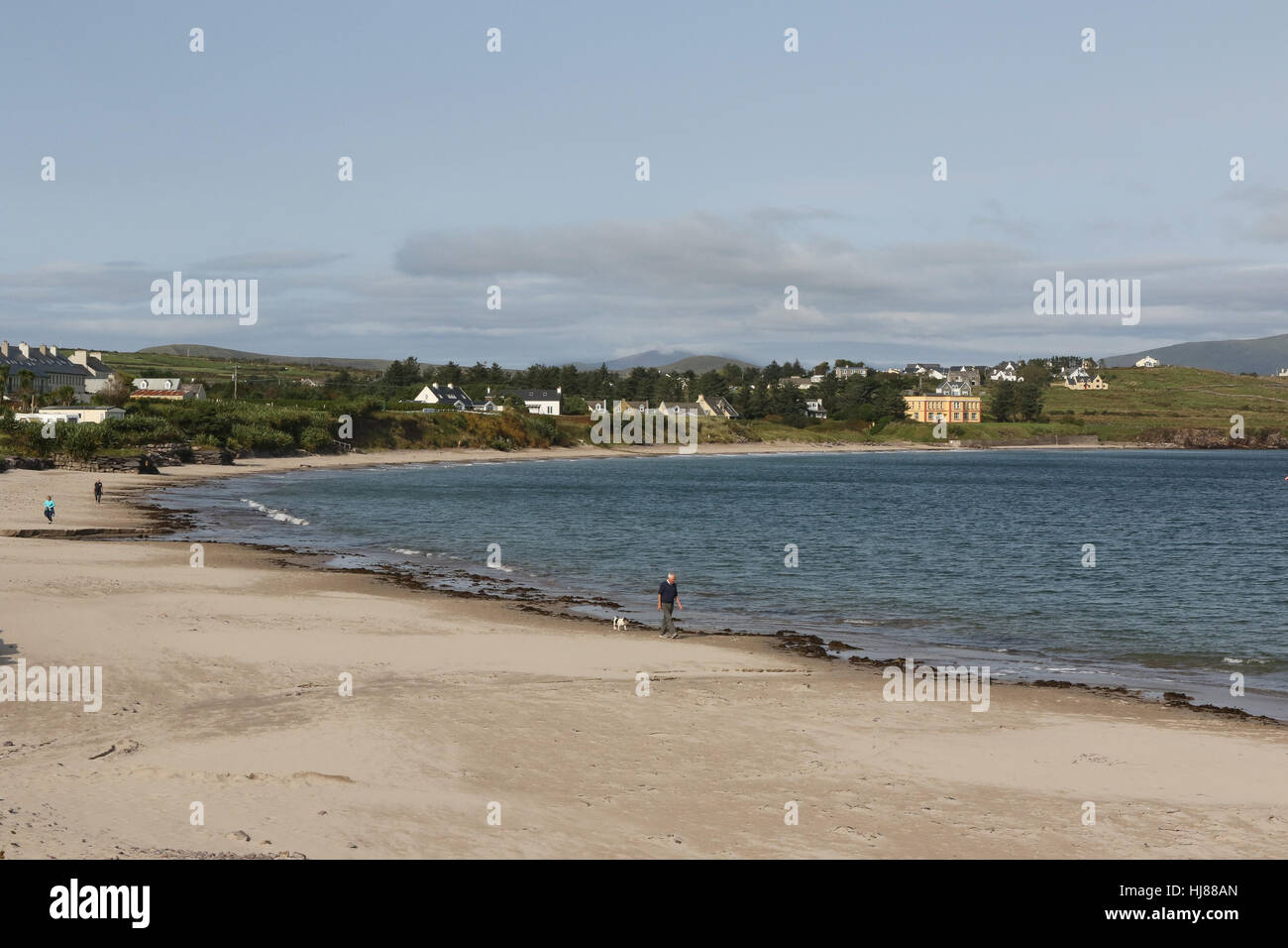 People walking on County Kerry beach. The sandy beach at Ballinskelligs ...