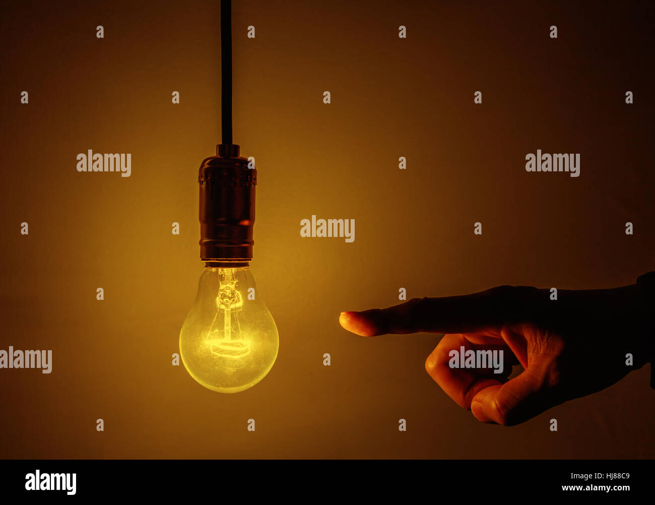 light bulb and hand with dark background Stock Photo - Alamy