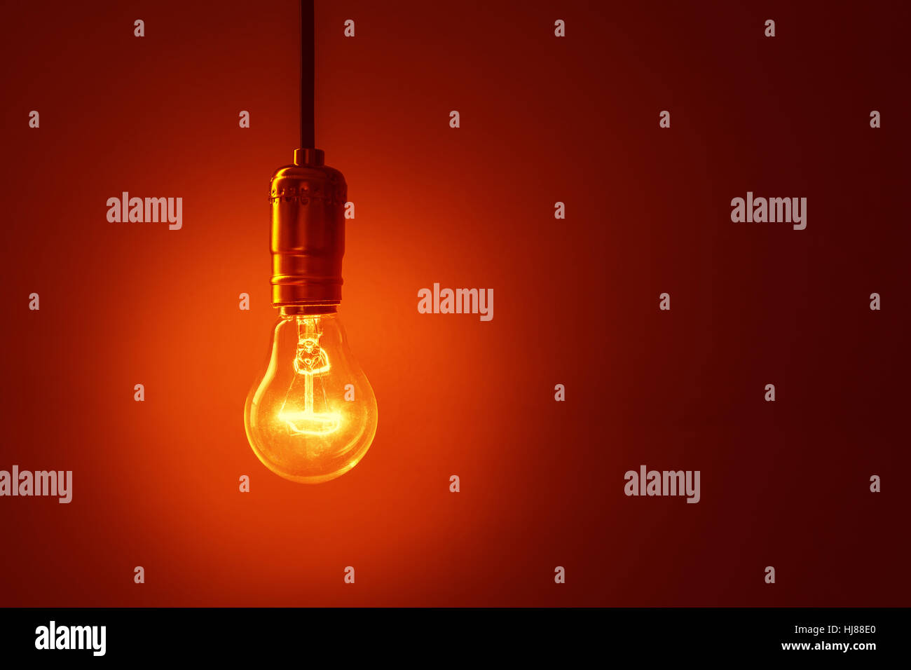 light bulb on red background Stock Photo - Alamy