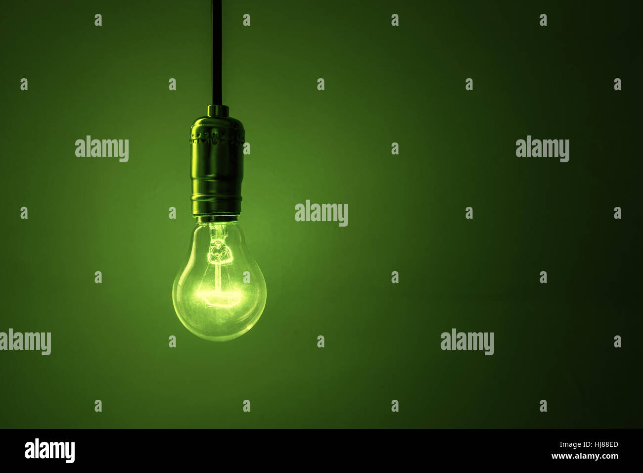 light bulb on green background Stock Photo - Alamy