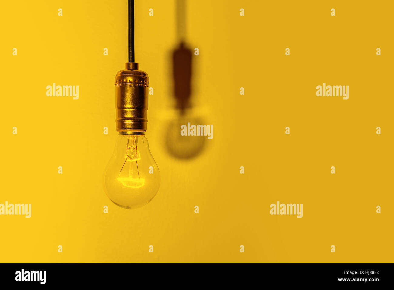 light bulb on yellow background Stock Photo - Alamy