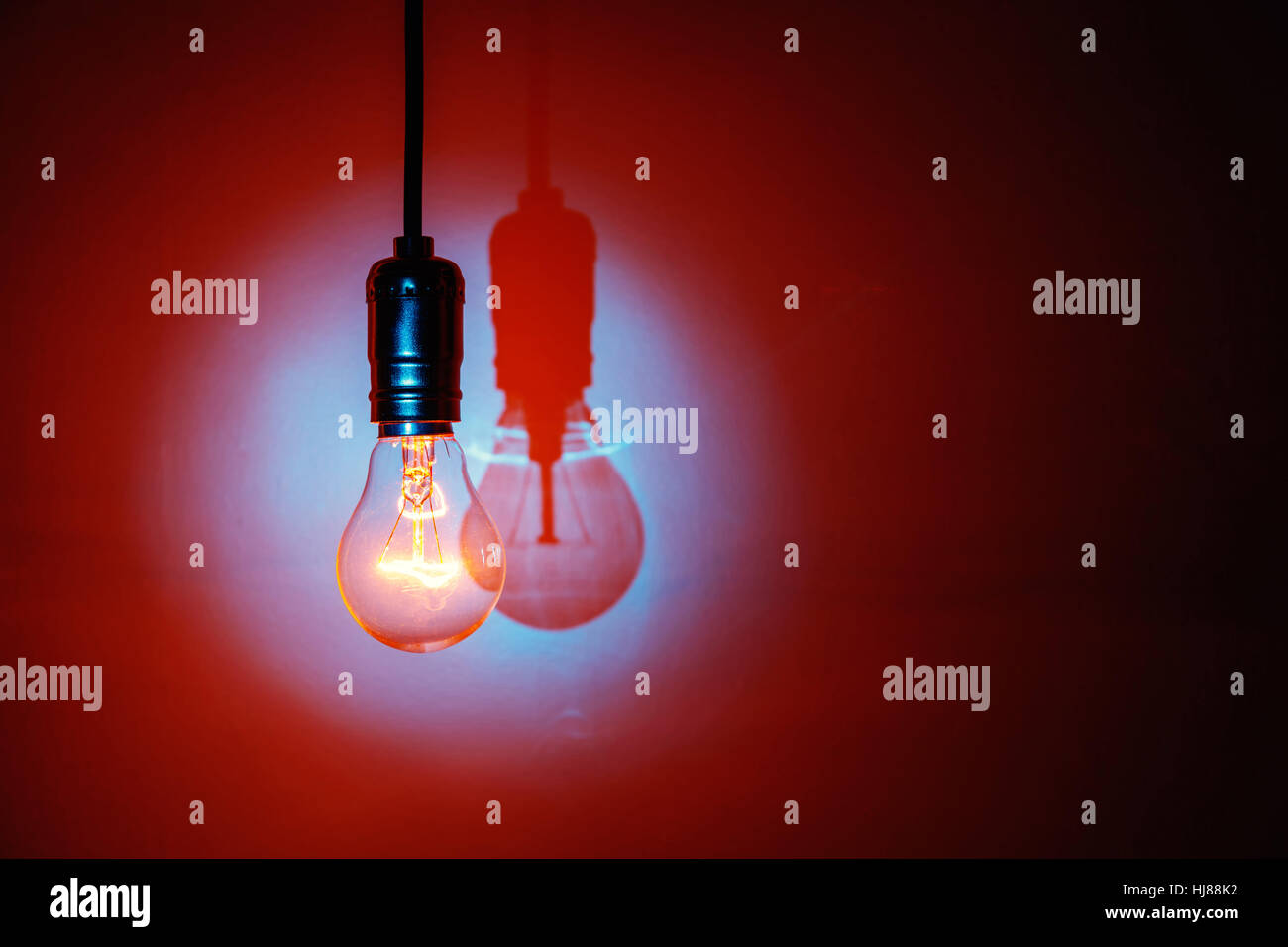 light bulb on red background Stock Photo - Alamy
