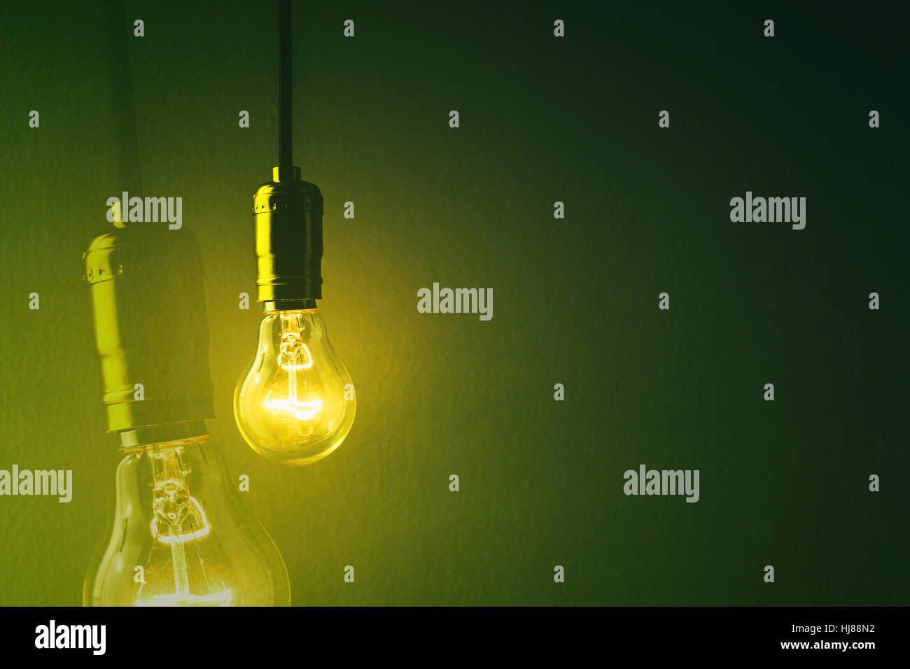 light bulb on green background Stock Photo - Alamy