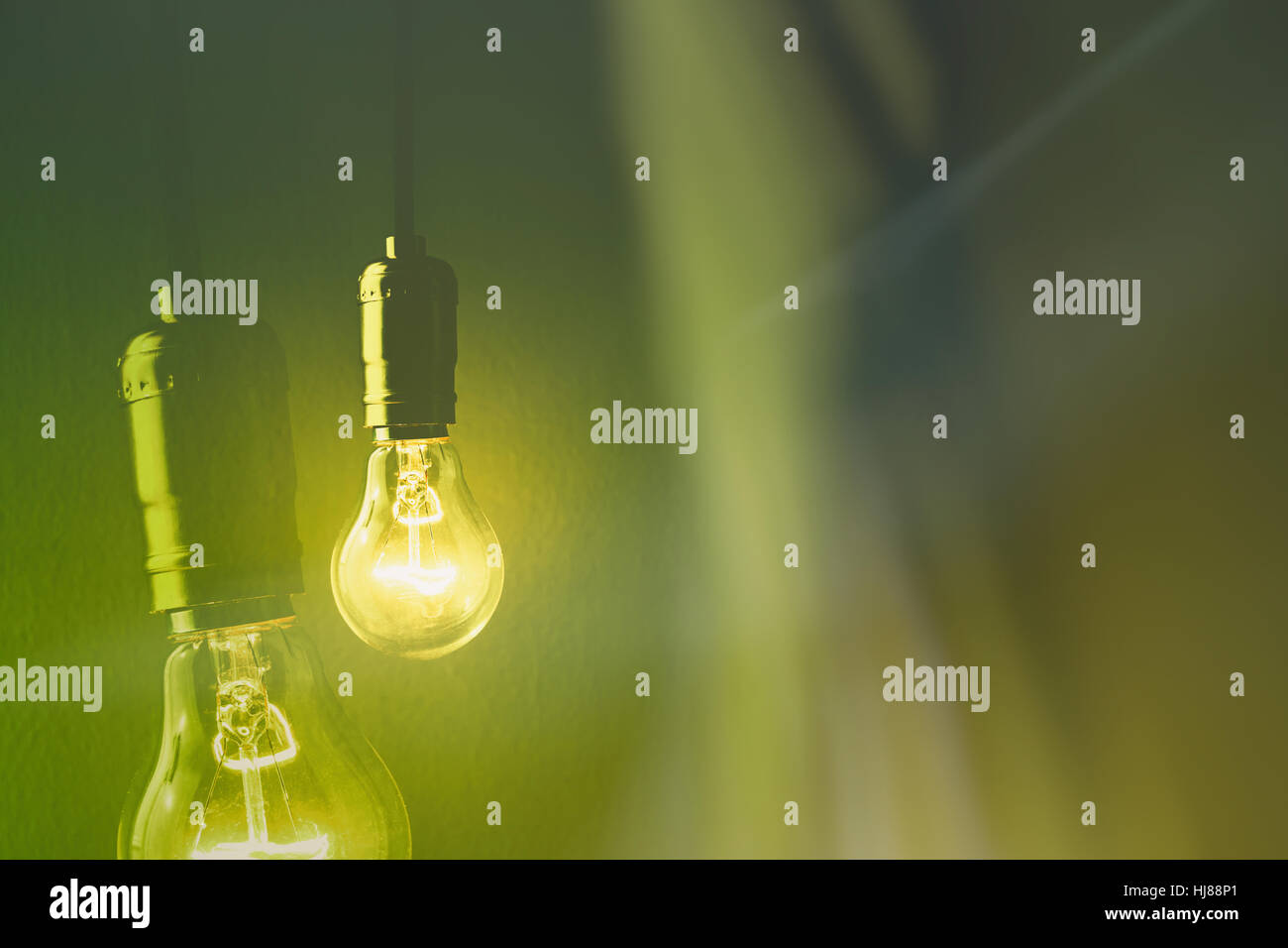 light bulb on green background Stock Photo - Alamy