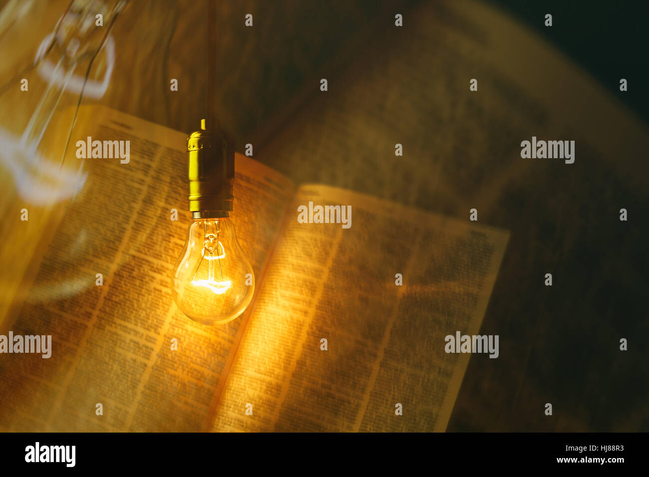 electric bulb illuminating a book Stock Photo - Alamy